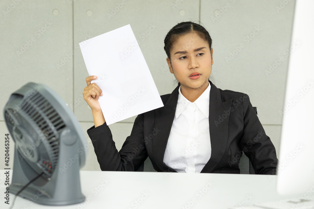 Foto de Young asian business woman feel upset due to hot weather of ...