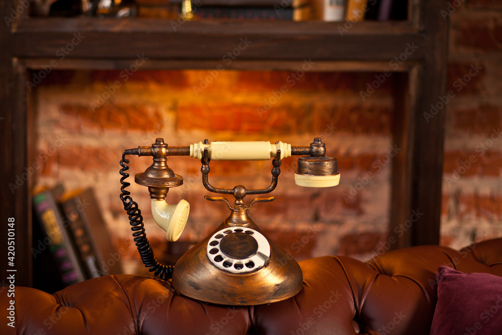 Vintage retro phone with rotary dial in interior on the brick wall and ...