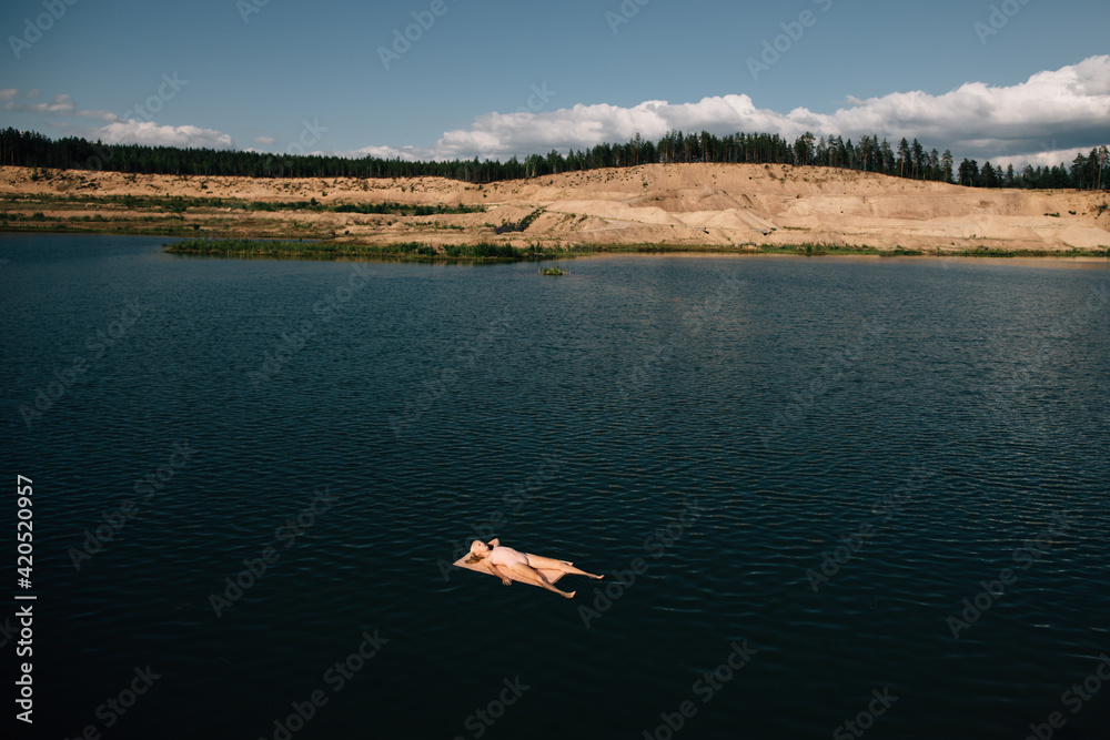 Little girl floating on plastic raft Stock Photo | Adobe Stock