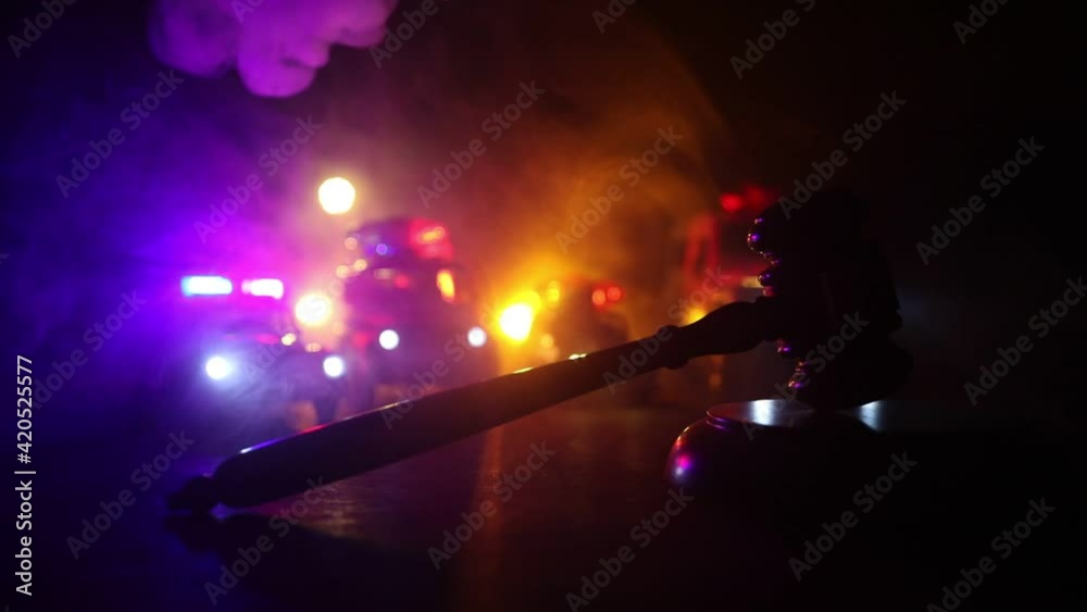Law theme, mallet of the judge on wooden desk . Silhouette of police ...