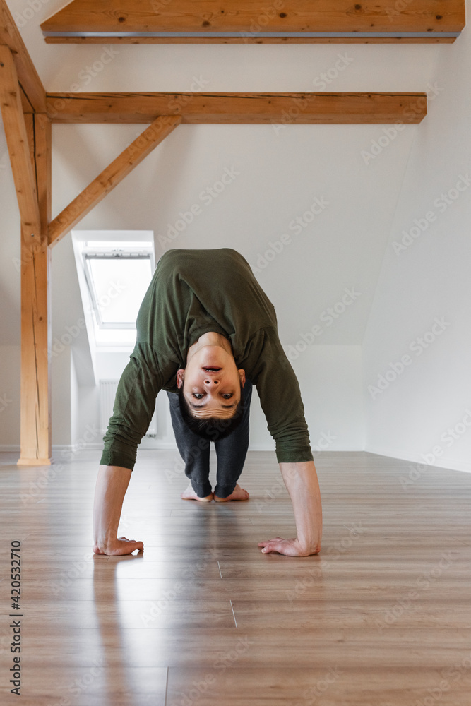 Flexible guy doing Wheel exercise Stock Photo | Adobe Stock