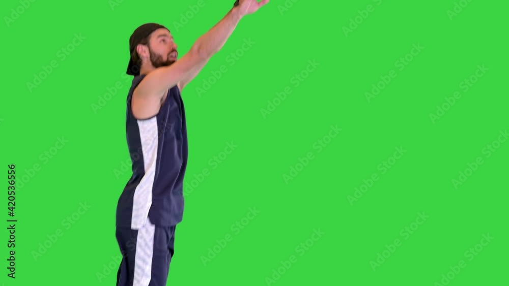 Basketball player throwing the ball after getting it while walking on a ...