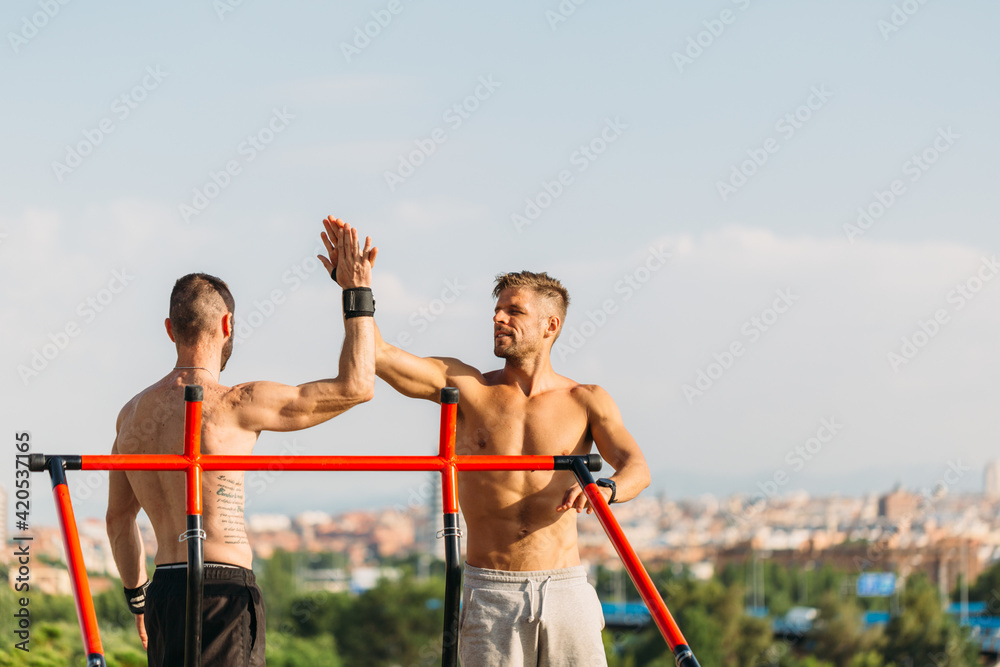 Shirtless sportsmen making high five gesture Stock Photo | Adobe Stock