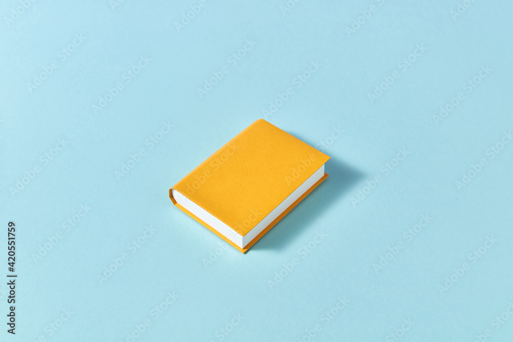 One yellow papercraft book made from paper. Stock Photo | Adobe Stock