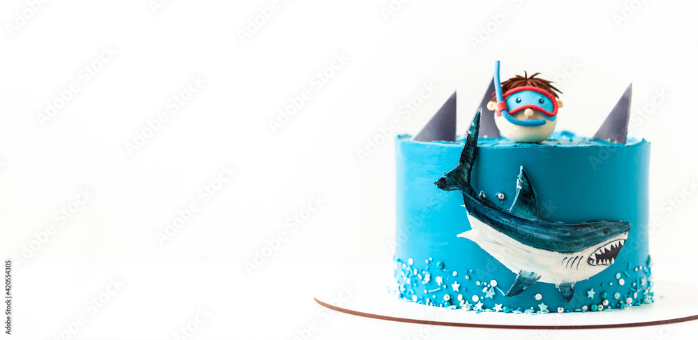Sea and shark themed cake with blue cream cheese frosting on the white ...