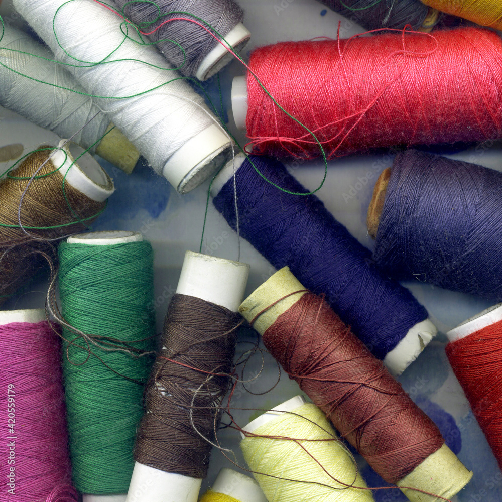 Colorful bobbin thread. Sewing. Colorful yarn on spool, yarn on tube ...