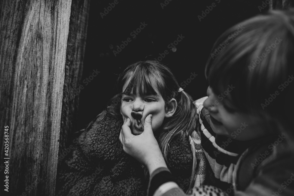 girl squeezing girls cheeks Stock Photo | Adobe Stock