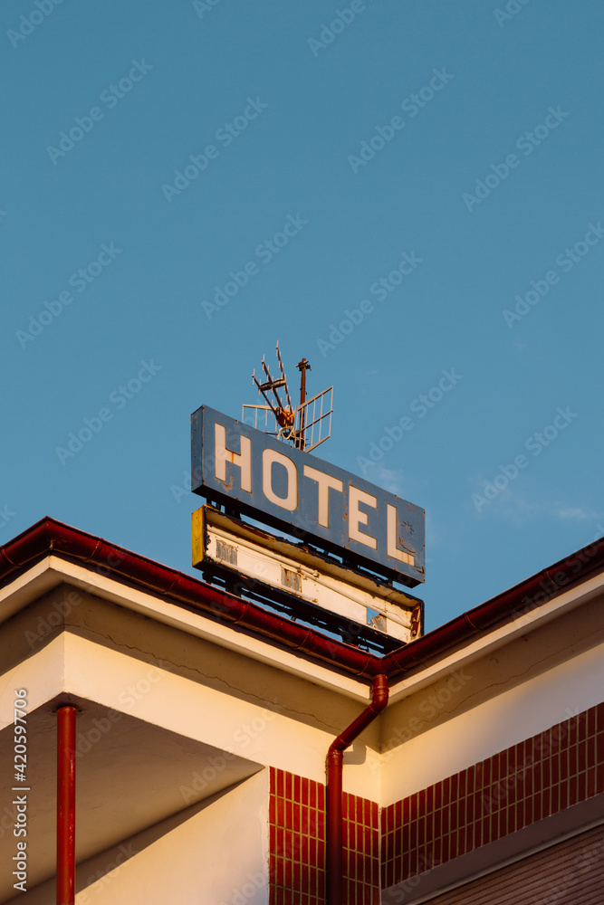 Hotel Red Sign on rural facade Stock Photo | Adobe Stock