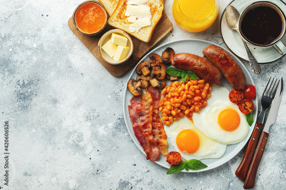 Full English breakfast on a plate with fried eggs, sausages, bacon ...