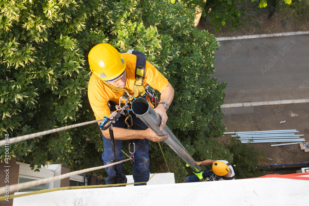 Working at elevations. Rope access, high-altitude outdoor work. Stock ...