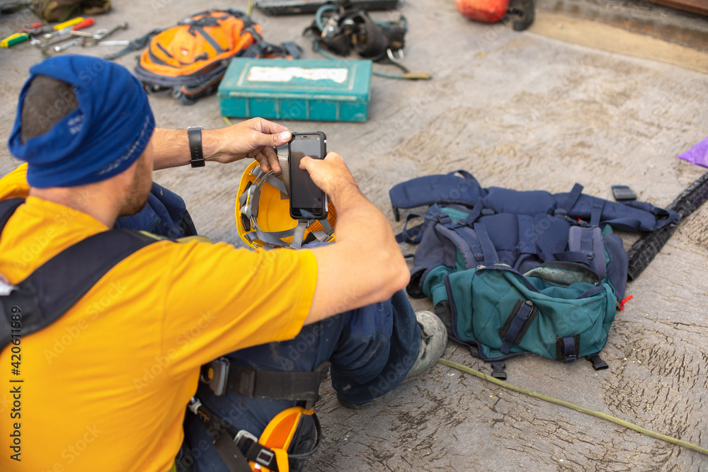Working at elevations. Rope access, high-altitude outdoor work. Stock ...