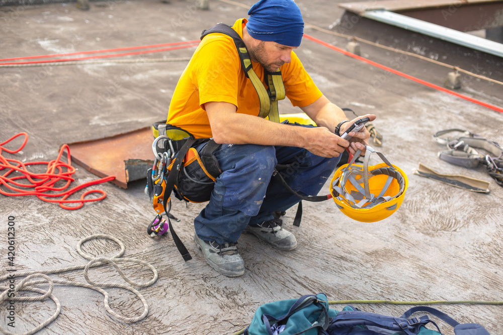 Working at elevations. Rope access, high-altitude outdoor work. Stock ...