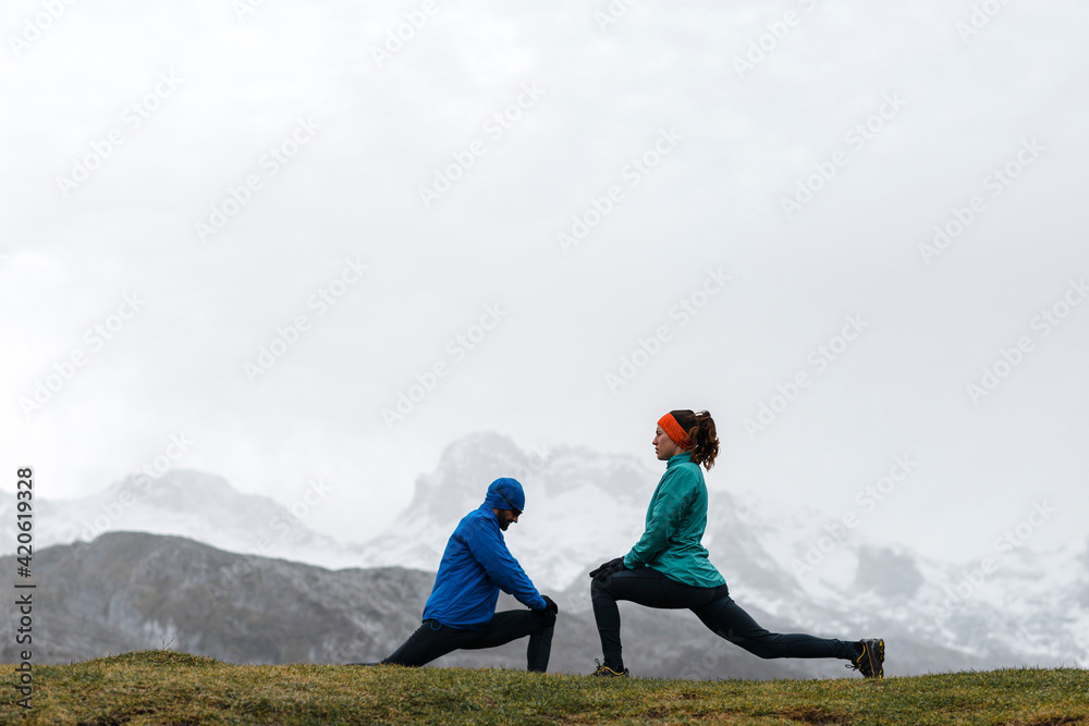Multi generational couple warming up during workout in nature Stock ...