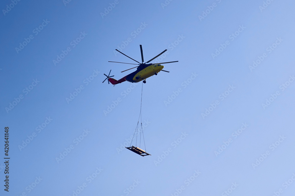 The world's largest cargo helicopter hovers overhead. Bottom view.The ...