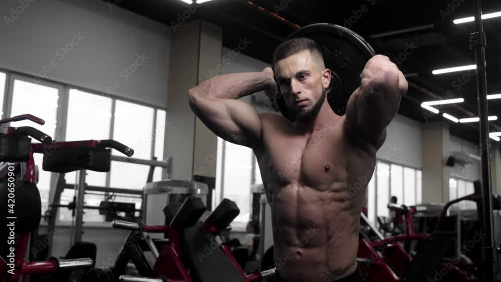 Strong bodybuilder with six pack muscular chest and shoulders in gym ...