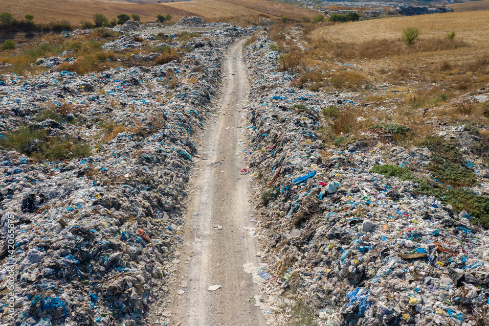 road to a garbage heap full on plastic pollution Stock Photo | Adobe Stock