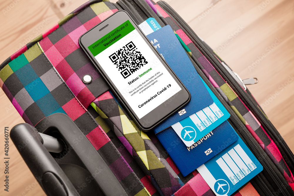 passport and a smart phone with a digital of a certificate of ...