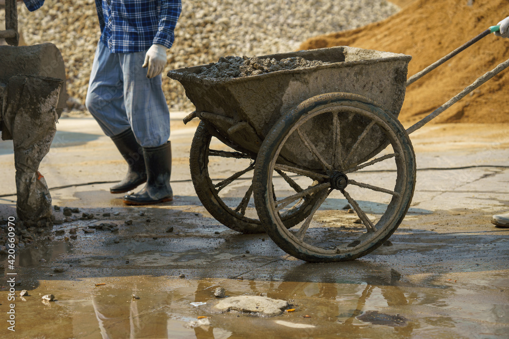 Construction workers carry building materials Stock Photo | Adobe Stock