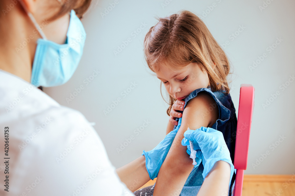vaccination of children. Doctor examining a child in a hospital. covid ...