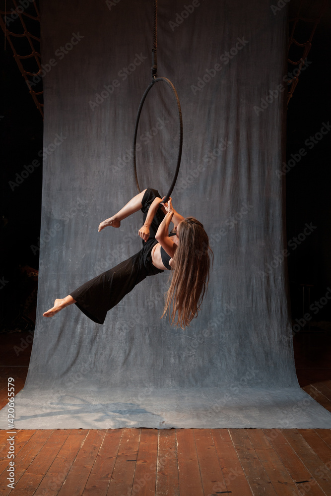 Aerial artist in a beautiful pose on a Lyra or Aerial ring Stock Photo ...