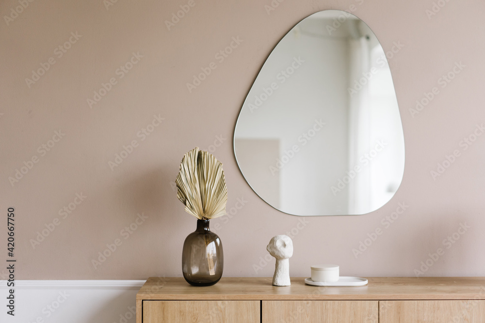 Mirror and wooden cabinet with decorative elements in room Stock Photo ...