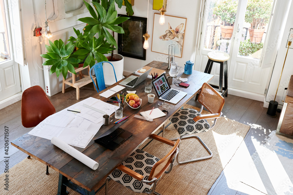 Laptops and paperwork on an office table Stock Photo | Adobe Stock