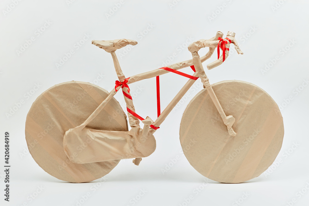 Creative gift on birthday bike wrapped of craft paper. Stock Photo ...