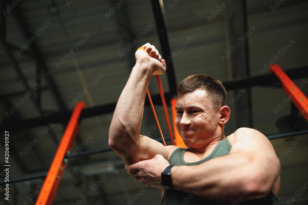 Man building up muscles of upper body Stock Photo | Adobe Stock