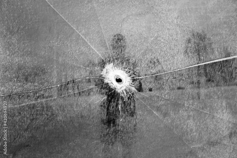 Self-portrayed with a glass broken by a bullet. Stock Photo | Adobe Stock