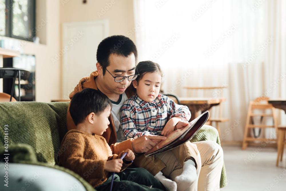 Reading book with kid at home Stock Photo | Adobe Stock