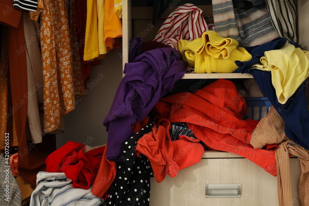 Messy wardrobe with different clothes. Fast fashion concept Stock Photo ...