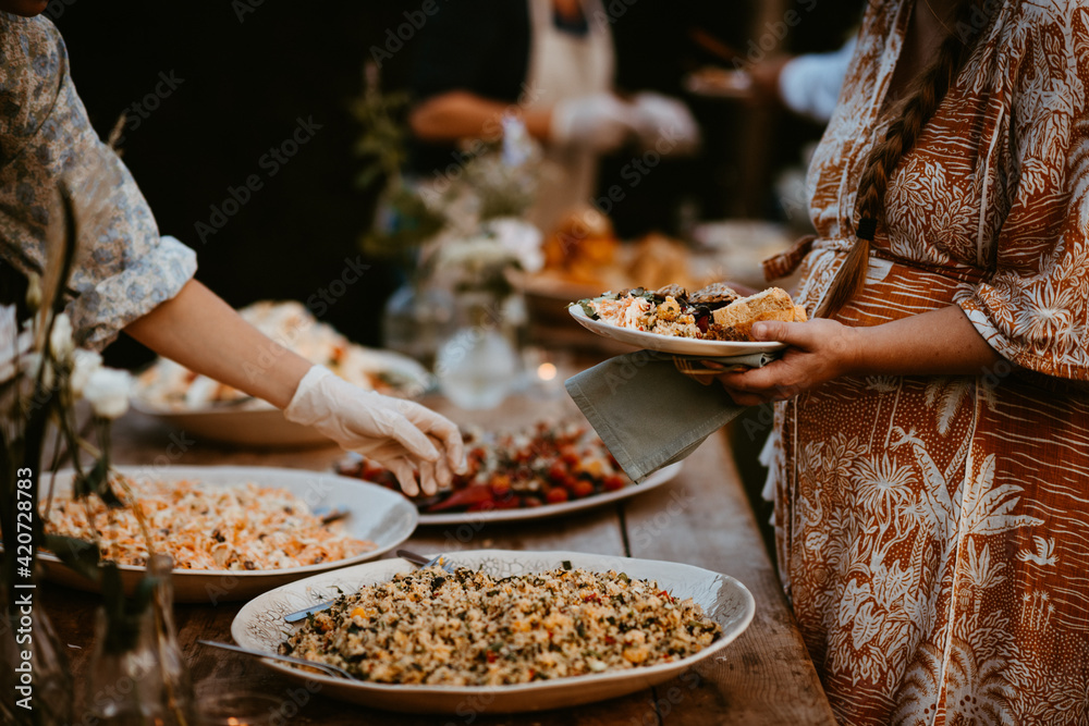 waiter serving food from buffet wearing gloves Stock Photo | Adobe Stock