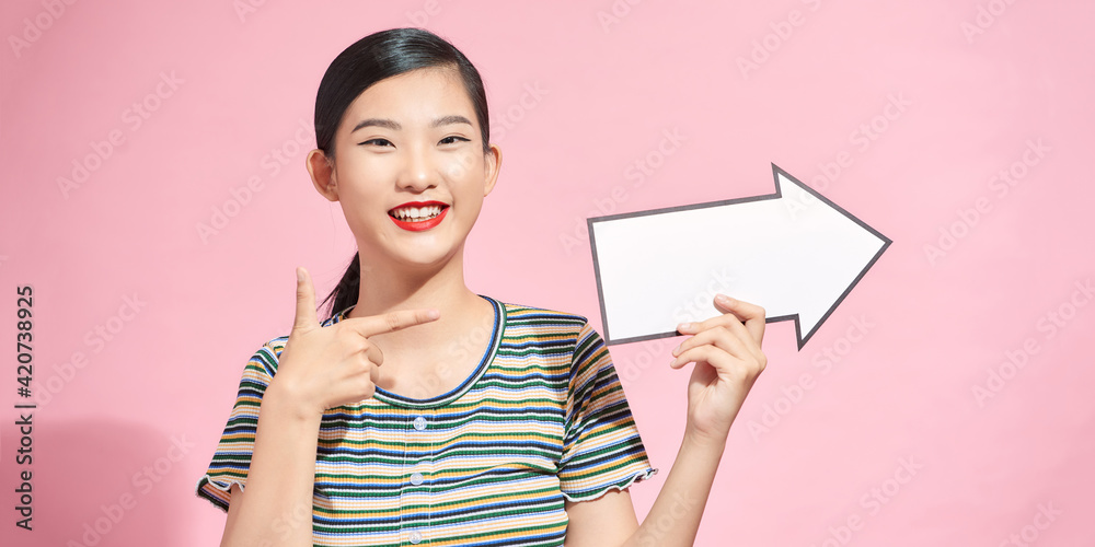 Young girl with right arrow banner isolated Stock Photo | Adobe Stock