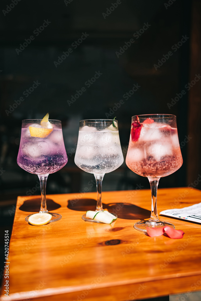 Beautiful line of multi-colored alcoholic cocktails at a party on the ...