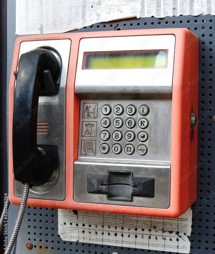 old metal public phone booth with buttons and orange border - retro ...
