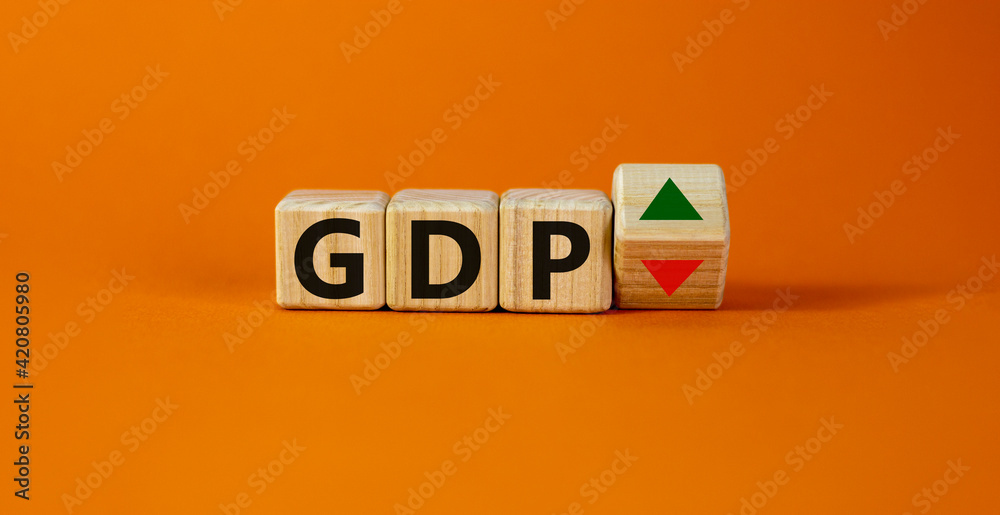 GDP, gross domestic product symbol. Wooden cubes with up and down icon ...