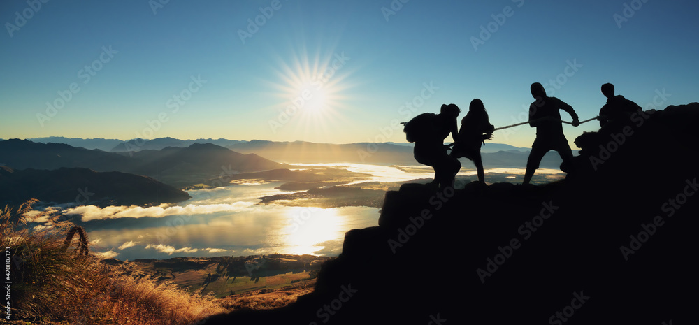 Young asian couple hikers climbing up on the peak of mountain. People ...