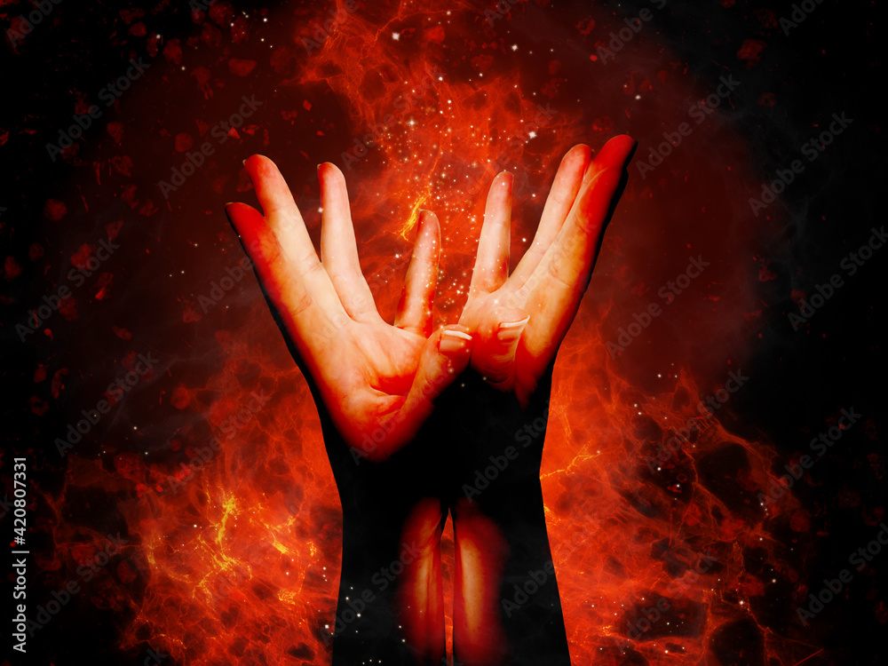 Hands reach up surrounded by flames and sparks. Celebration for Beltane ...