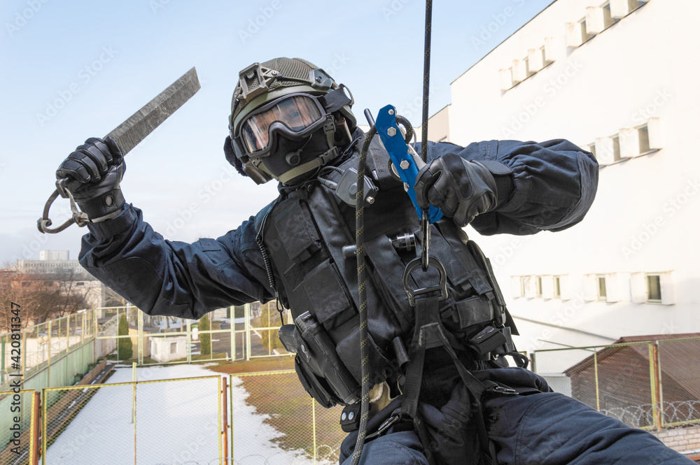Special forces soldier storms the building through the window. Training ...
