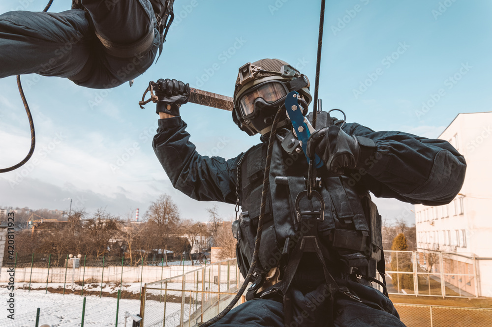 Special forces soldier storms the building through the window. Training ...