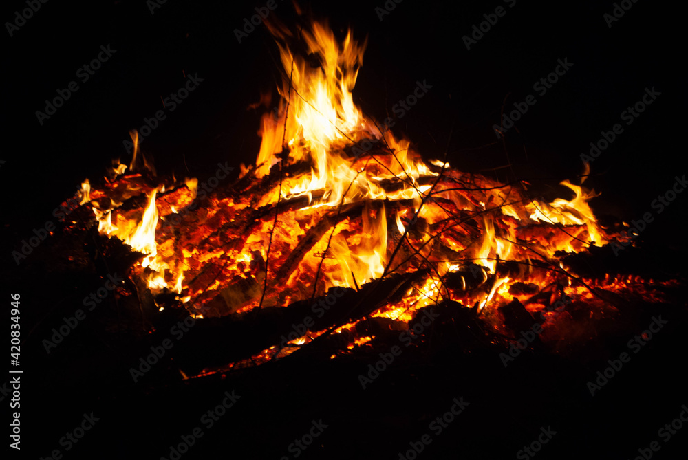 Burning bonfire on Novruz. Firewoods on fire. A dying fire. A bright ...