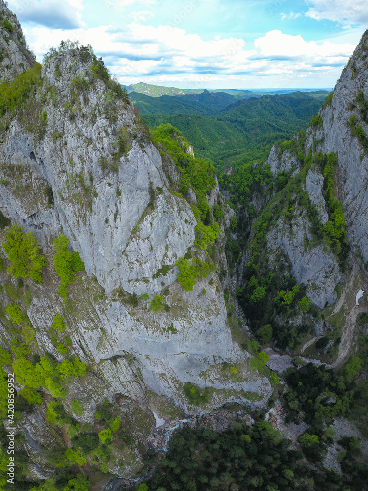 Aerial drone view over Cheia's river abrupt and vertical gorges. This ...