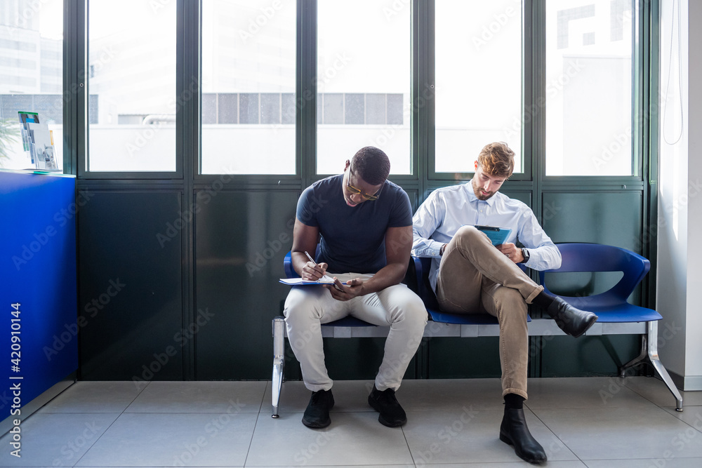 Patients completing forms at hospital reception Stock Photo | Adobe Stock