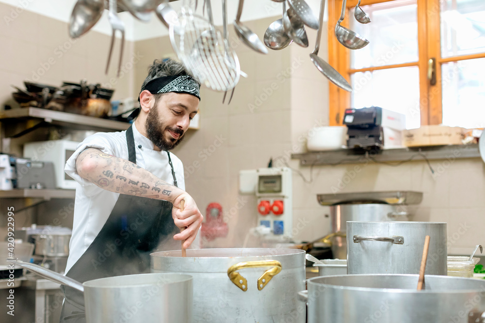 Chef cooking in kitchen Stock Photo | Adobe Stock