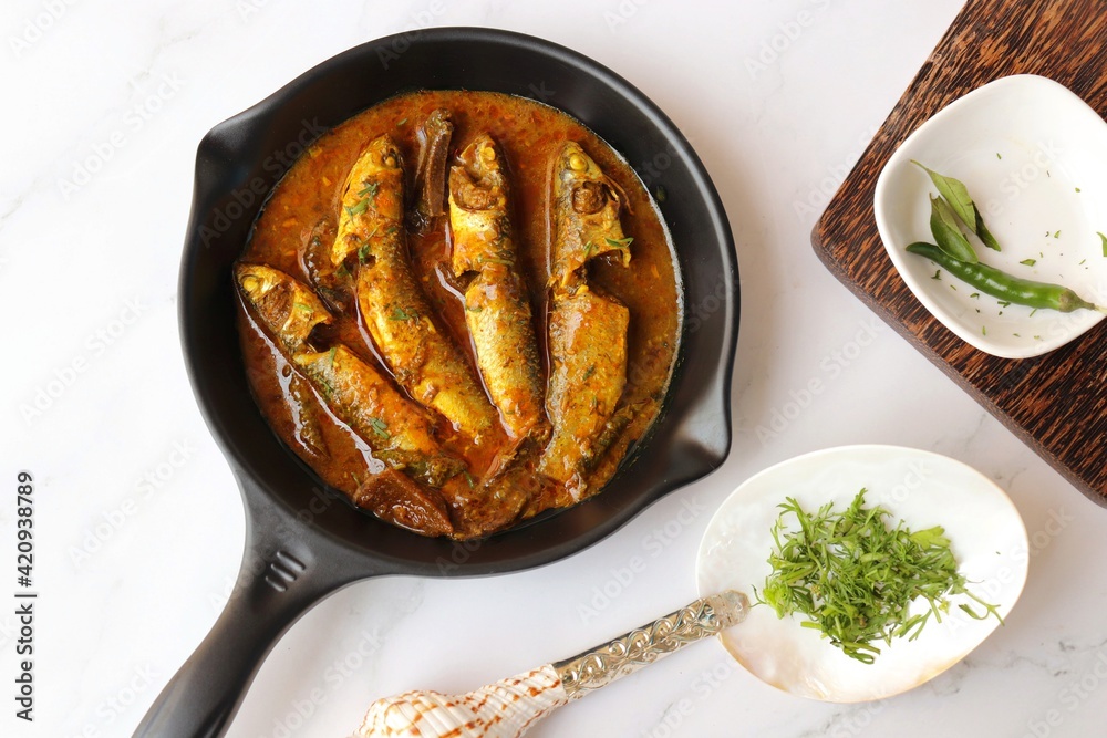 Indian fish curry. White Mullet fish curry made with dried mango and ...
