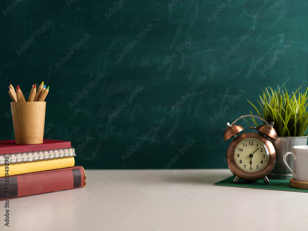 Study table with school elements, cup, clock and copy space in class ...
