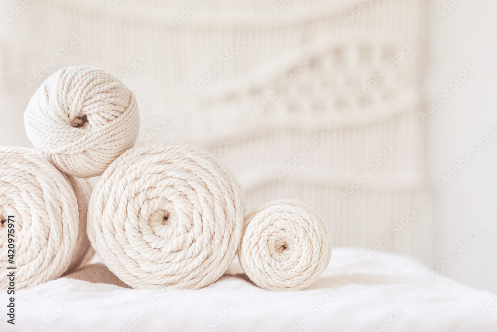 Handmade macrame braiding and cotton threads on white background. Light ...