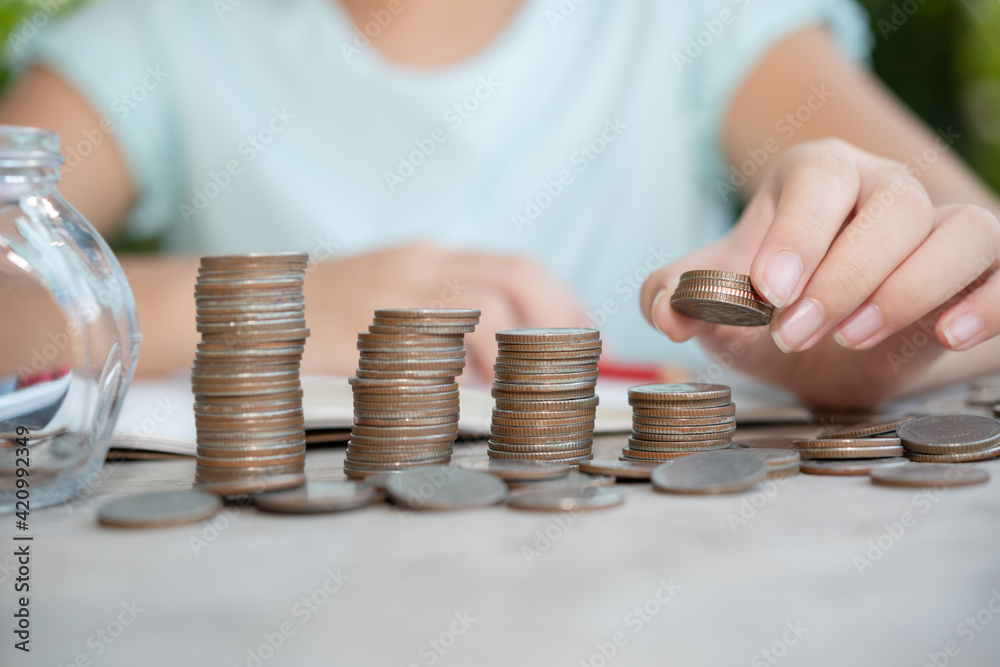 Cute asian little girl playing with coins making stacks of money,kid ...