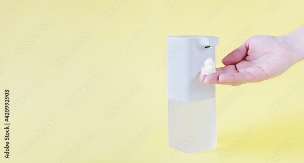 female hand using Automatic touchless soap dispenser hand washing ...