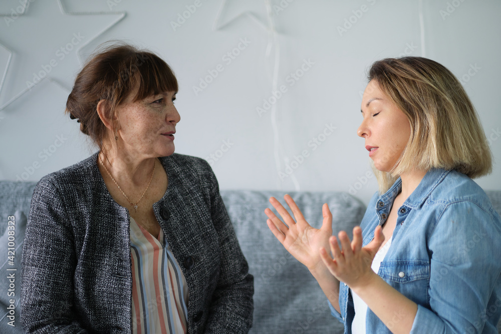 adult daughter talking to his elderly mom. mother and daughter having ...
